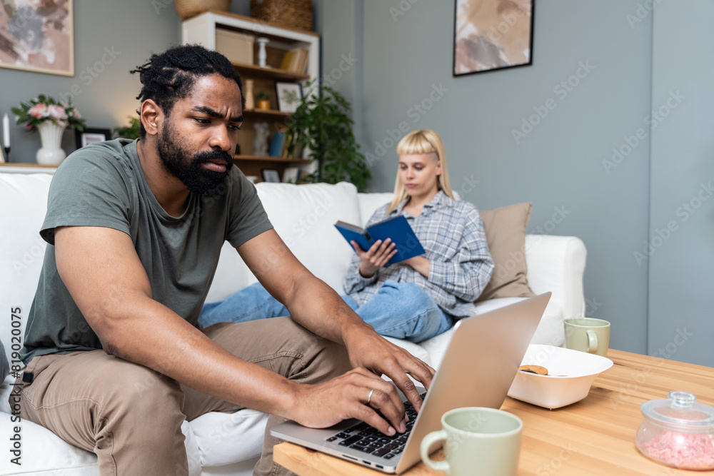 Simple living. Young couple man and woman at home working on laptop ...