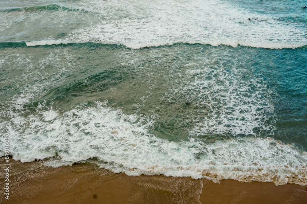 Surfers in the ocean. Panorama view of Praia do Tonel in Cape Sagres ...