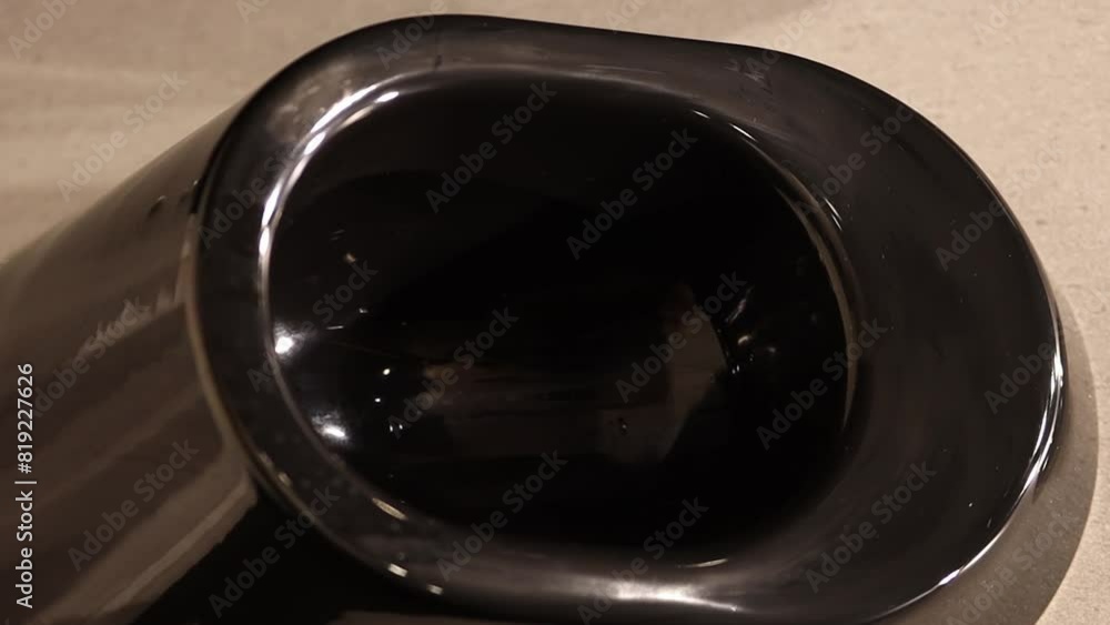 Modern black urinal in a public toilet. Clean black toilet-urinals in a ...