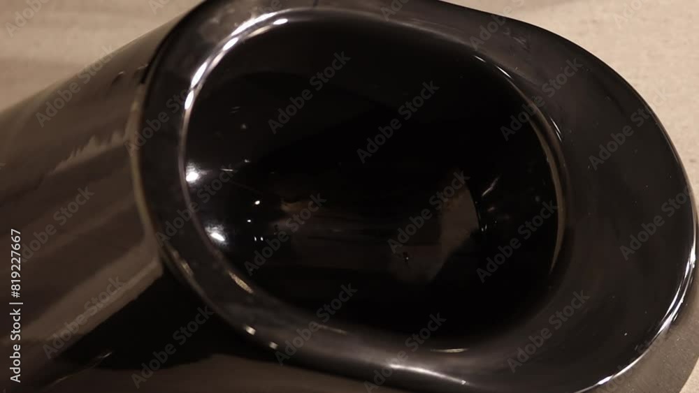 Modern black urinal in a public toilet. Clean black toilet-urinals in a ...