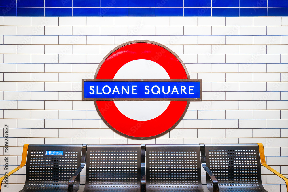 2024, Sloane Square tube station sign above a steel bench with bright ...