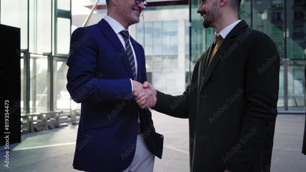 Two caucasian businessmen shaking hands to close a work deal. Male ...