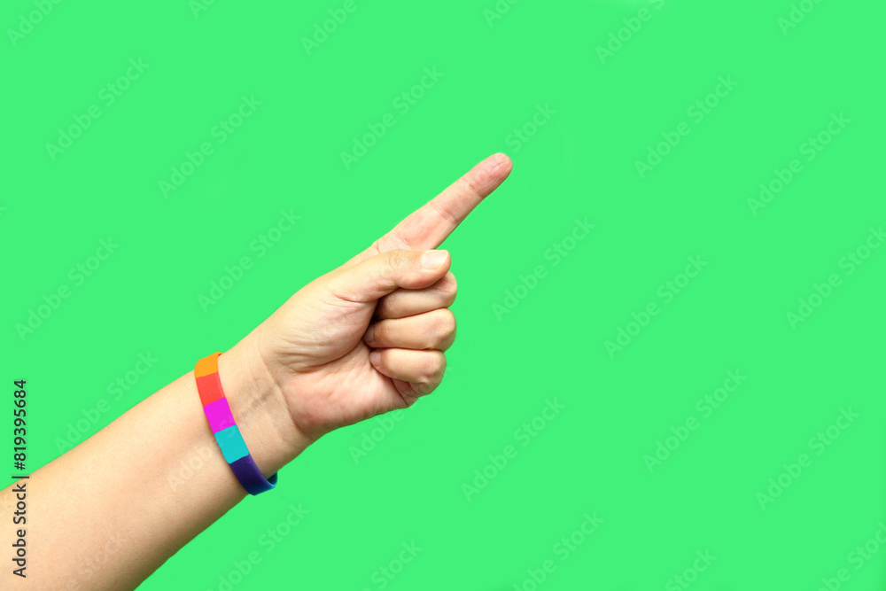 Hand with colorful bracelet as a symbol of the gay flag on the wrist ...