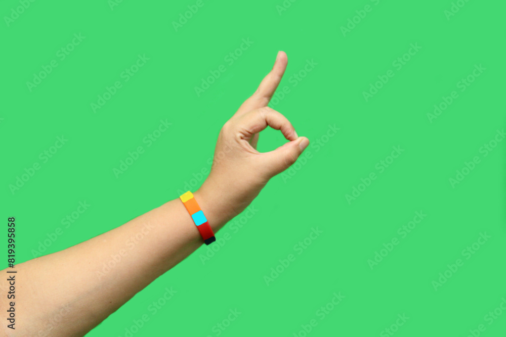 Hand with colorful bracelet as a symbol of the gay flag on the wrist ...