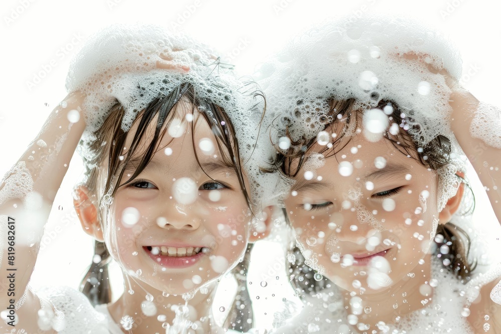 Asian kids with glowing skin, washing hair with bubbles and soap foam ...
