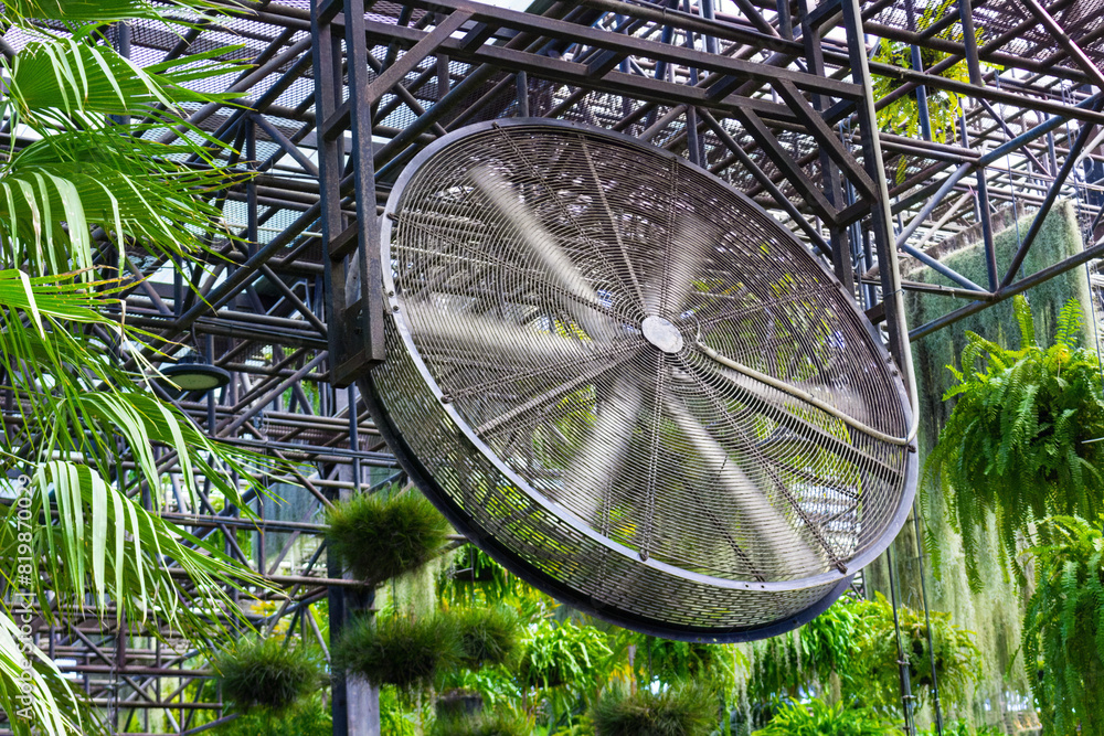 Giant spinning electric industrial type cooling fan to create humidity ...