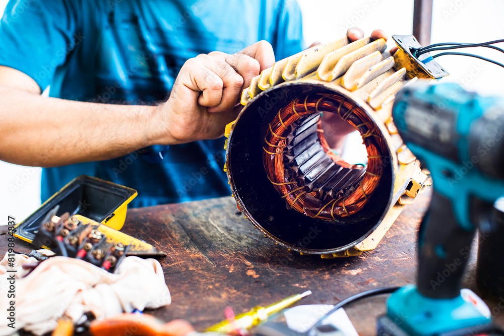 Copper windings inside an electric motor. The mechanic is repairing an ...
