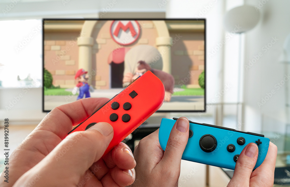 Close up of hands og people playing Mario vs. Donkey Kong on a new ...