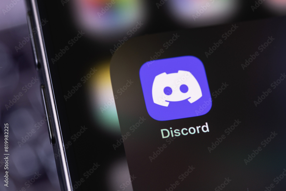 Discord icon app on a screen smartphone iPhone. Discord is a cross ...