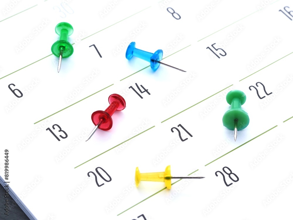 Push pins on a monthly calendar. Tools for marking events on a schedule ...