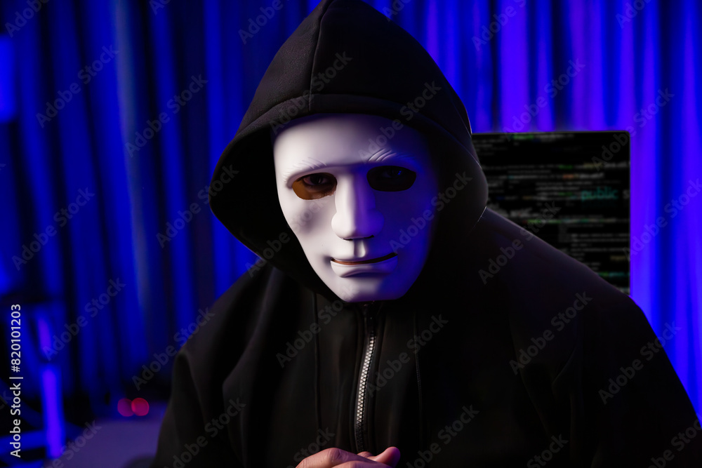 White criminal anonymous mask looking at camera pose of profile ...