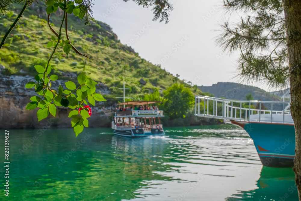 Halfeti village and its submerged minaret and Turkish flags of toursit ...