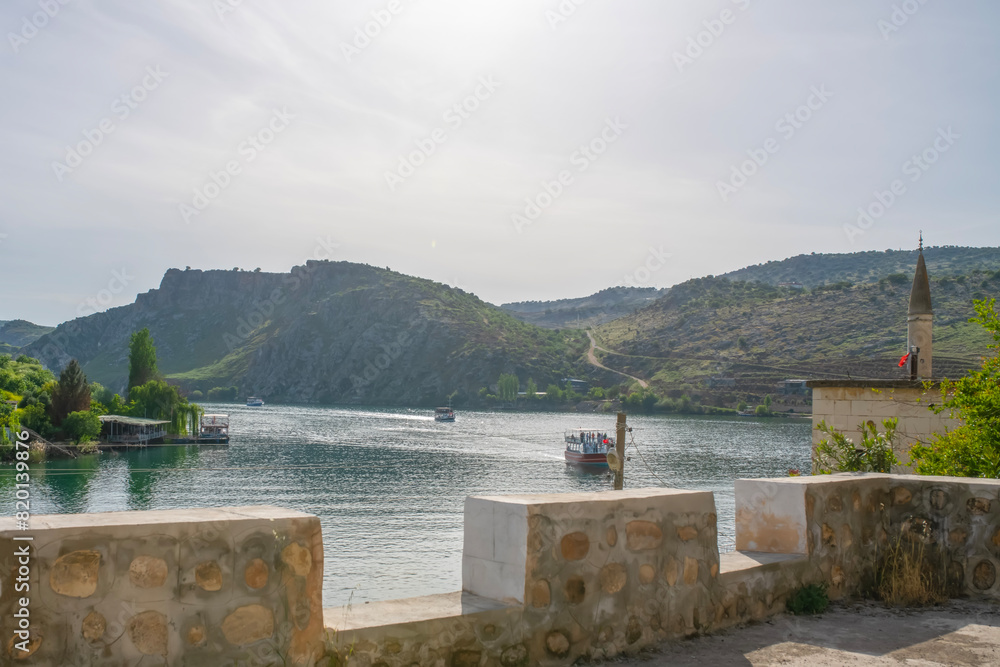 Halfeti village and its submerged minaret and Turkish flags of toursit ...