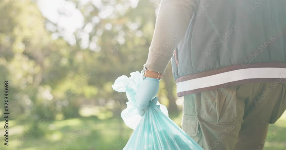Volunteer, cleaning and person in park for trash, plastic and litter ...