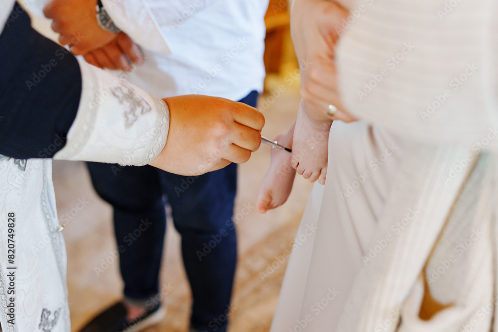 The priest conducts the process of anointing with oil for baptism. Christian faith and ...
