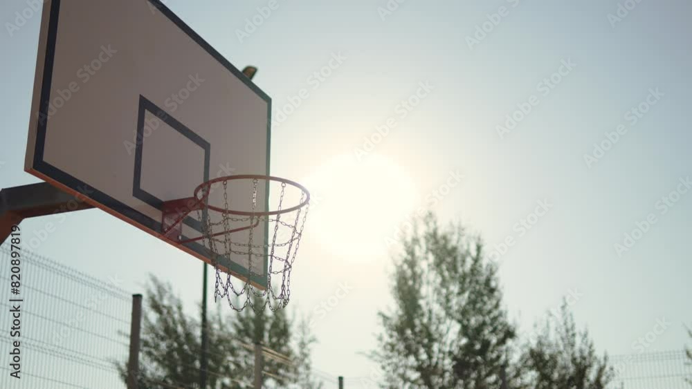 Gimbal shot of throwing ball into basketball hoop without people ...