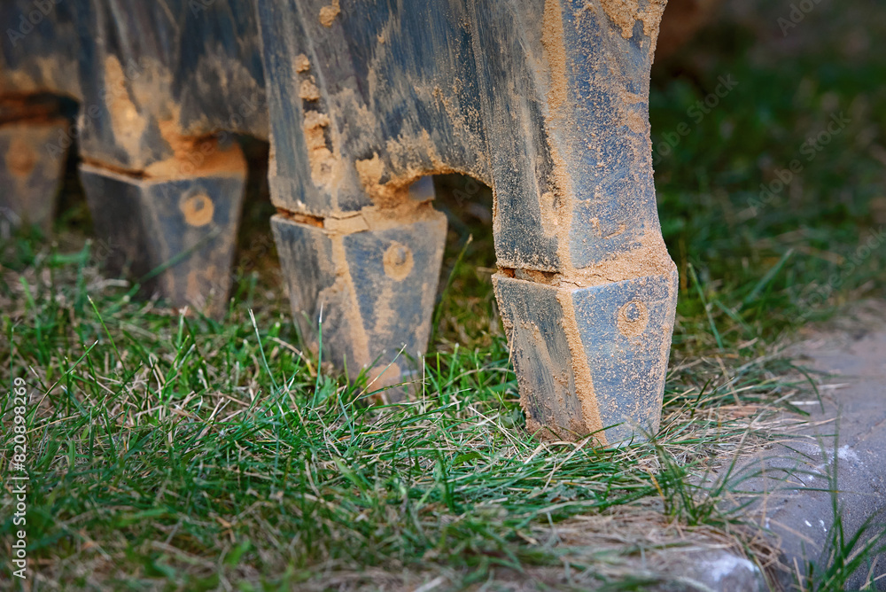 Excavator bucket teeth biting into the ground closeup. Detailed view of ...