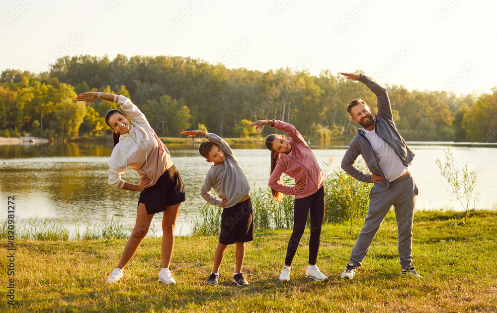 Joyous family, accompanied by children, comes together for a fitness at ...