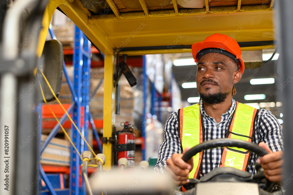 warehouse worker driving a forklift at shipping warehouse. Industrial ...