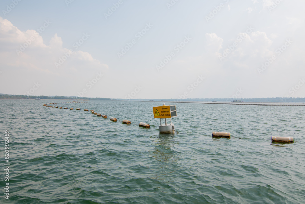 Seascape with floating buoys and rope separation area on the beach. A ...