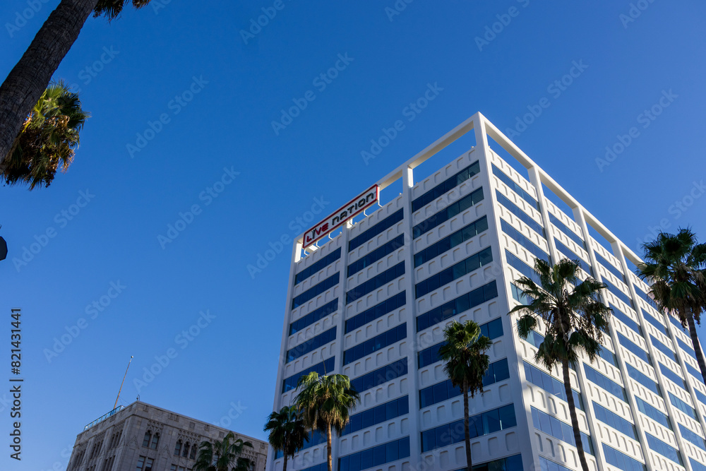 The Live Nation building along Hollywood blvd with tall lush green palm ...