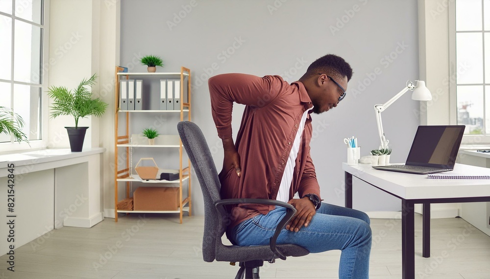 Office Worker Experiencing Lower Back Pain. Concept Desk Setup ...