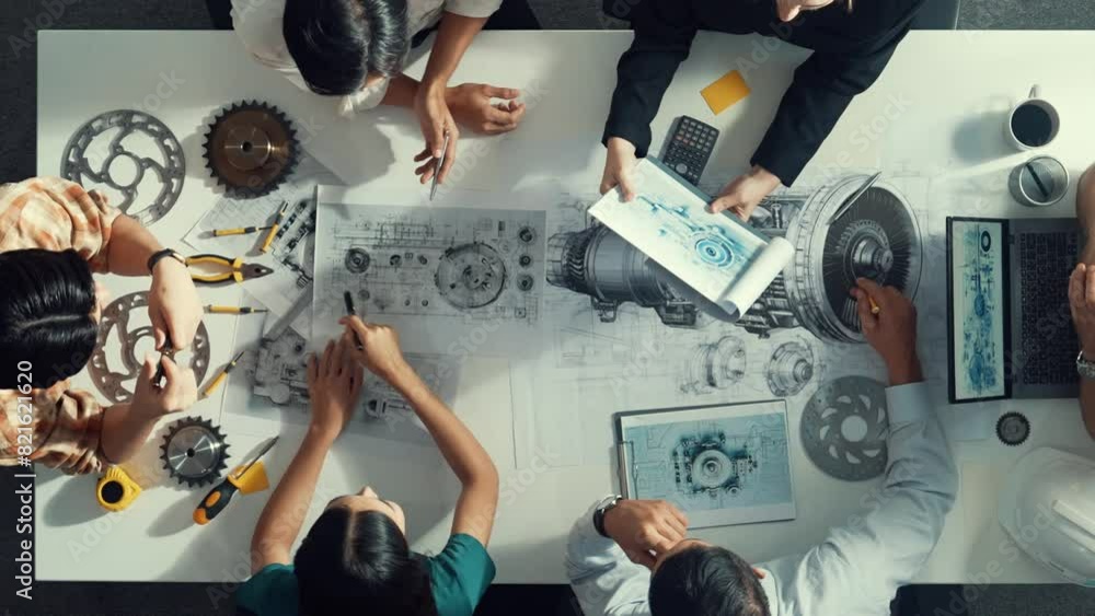Top down aerial view of smart engineer team working together to design ...