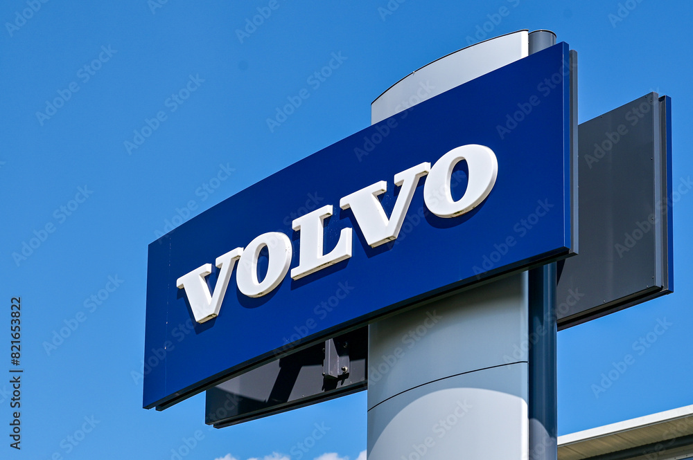 Volvo dealer sign, Service, logo sign, in front of blue sky. Volvo is a ...