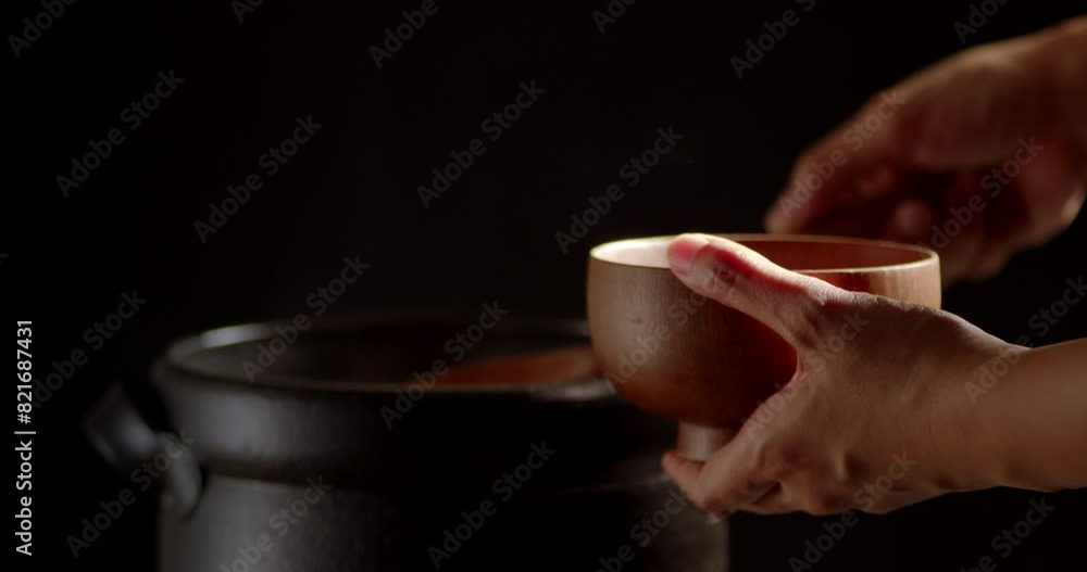 Slow motion vintage style scene while the cook is cooking rice porridge ...