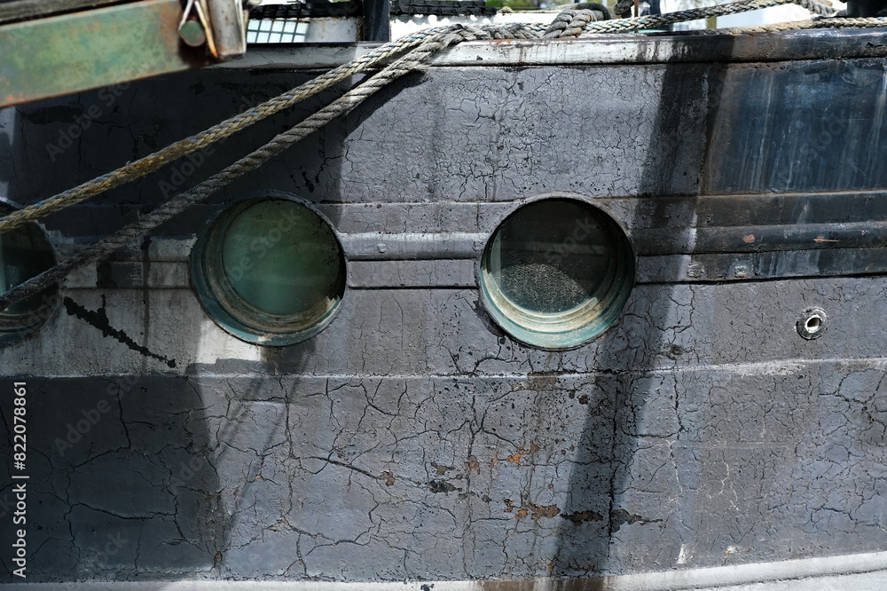 Portholes of an old ship. Boat side, paint cracks. A forgotten ship, an ...