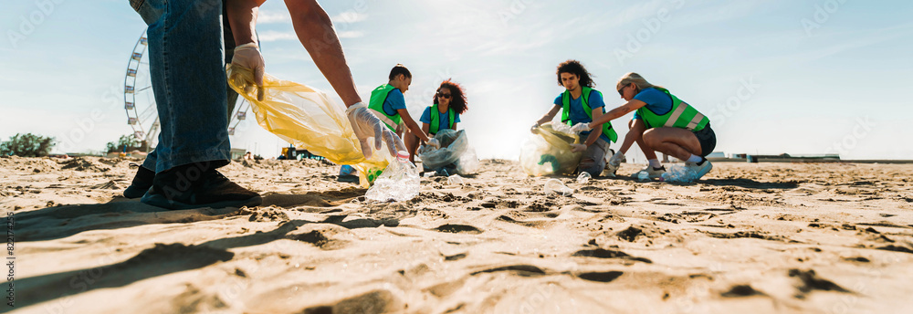 Group of eco volunteers picking up plastic trash on the beach ...