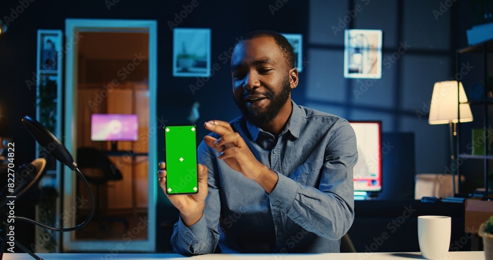 Content creator holding green screen product, being sponsored by tech ...