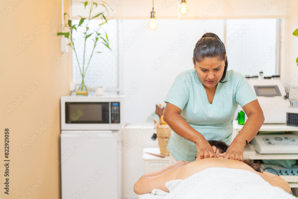 Masseur treating the back contractures of a female patient Stock Photo ...