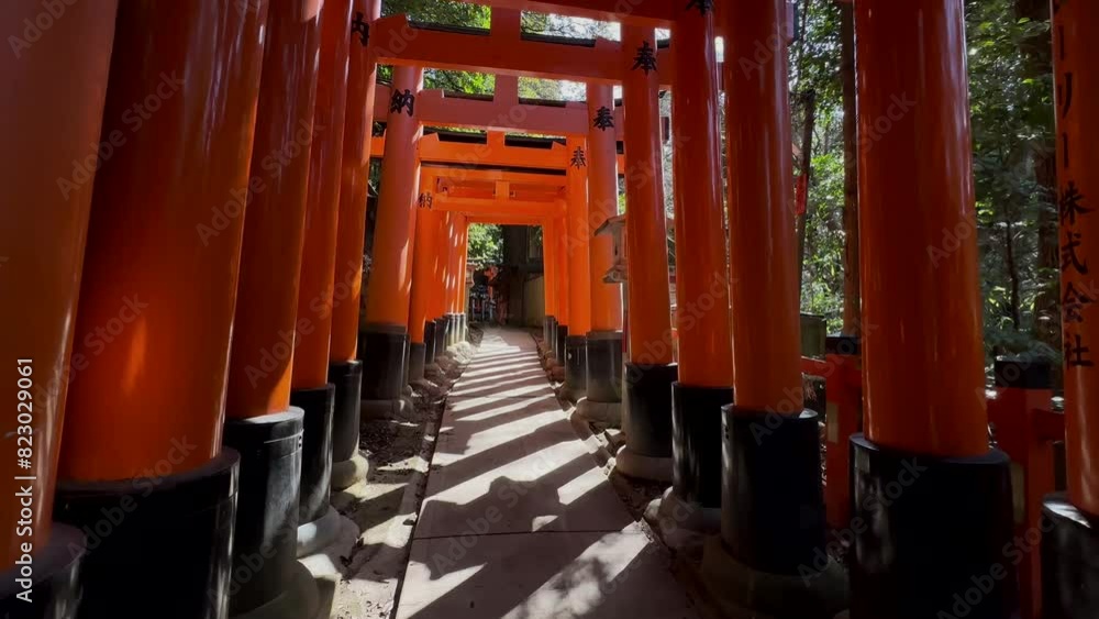 Slow motion low angle walk through the arches of Fushimi Inari Taisha ...