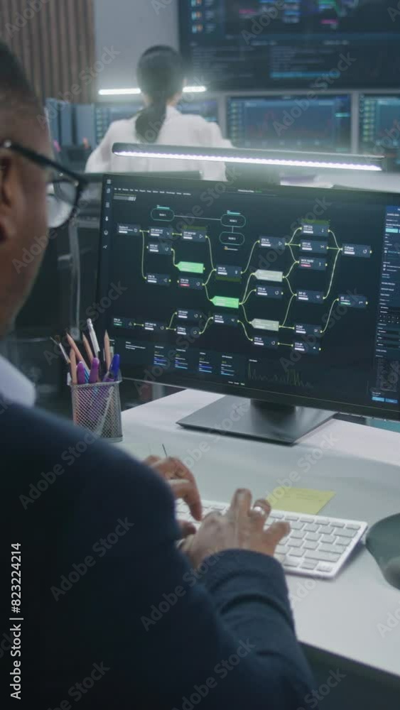 African American big data scientist works at computer with displayed ...
