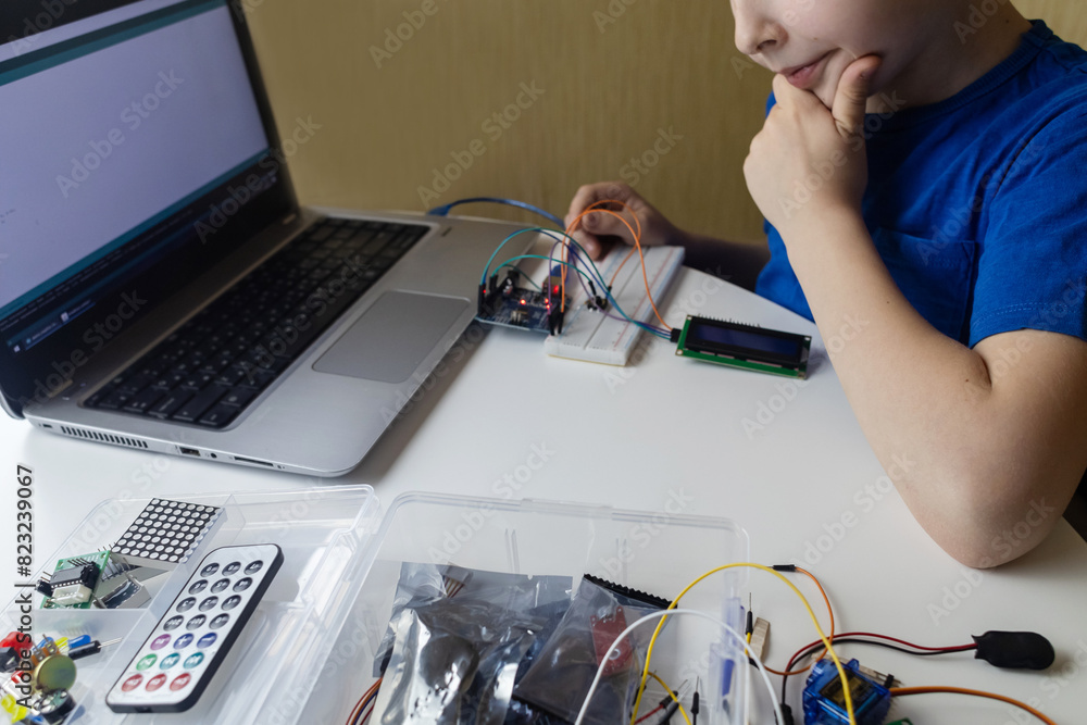 Programming for children. The boy is studying online at a robotics ...