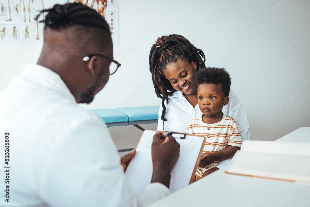 Smiling caring male pediatrician talk consult small boy patient at ...