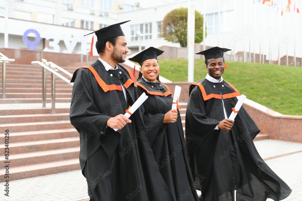Diverse international students with diplomas attending graduation ...
