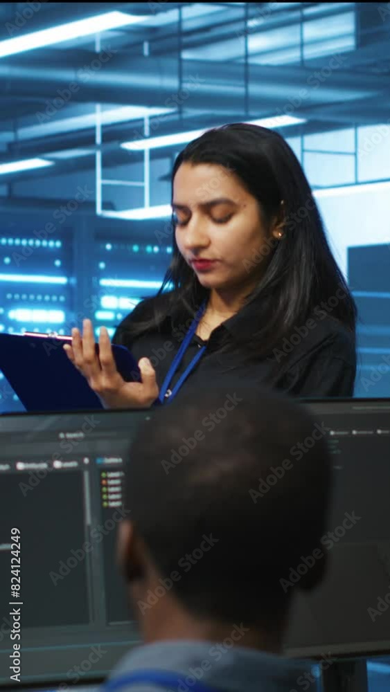 Vertical video Manager overseeing server room, walking around with ... Vertical video Manager overseeing server room, walking around with ...