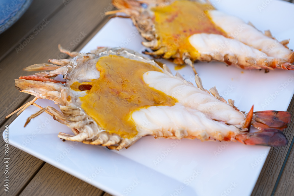 Large river prawns are grilled and cut in half to reveal the meat and ...