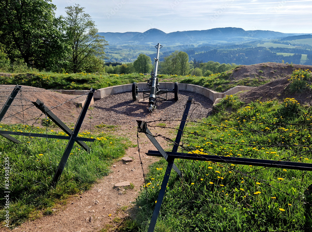 gun position behind wire barriers in trench. anti-tank measures made of ...