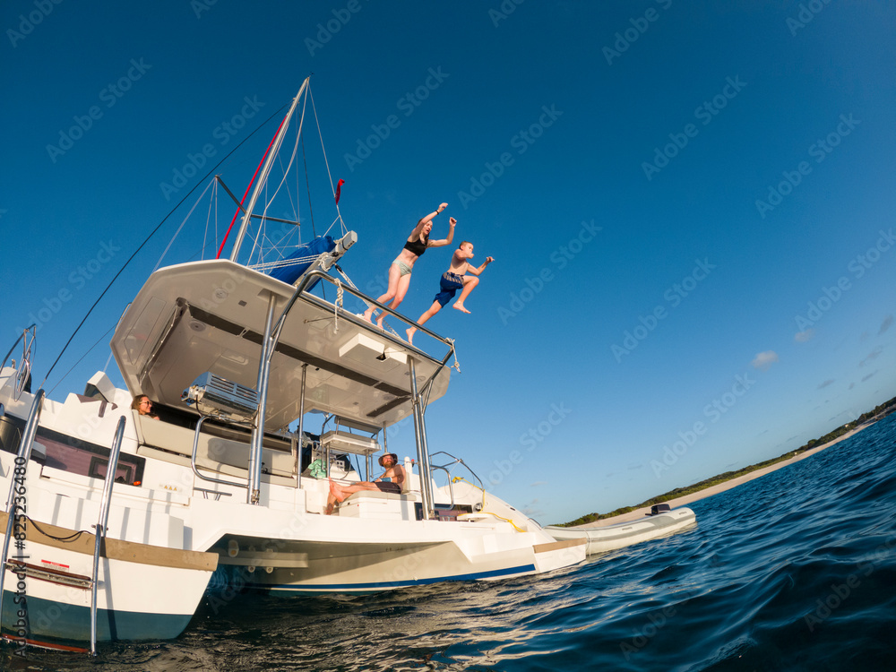 Adventure Travel boating in Caribbean with kids jumping into sea Stock ...