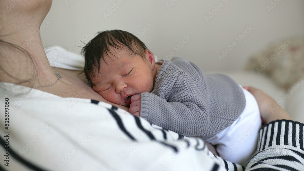 Baby newborn resting on mother's chest sleeping during first days of ...