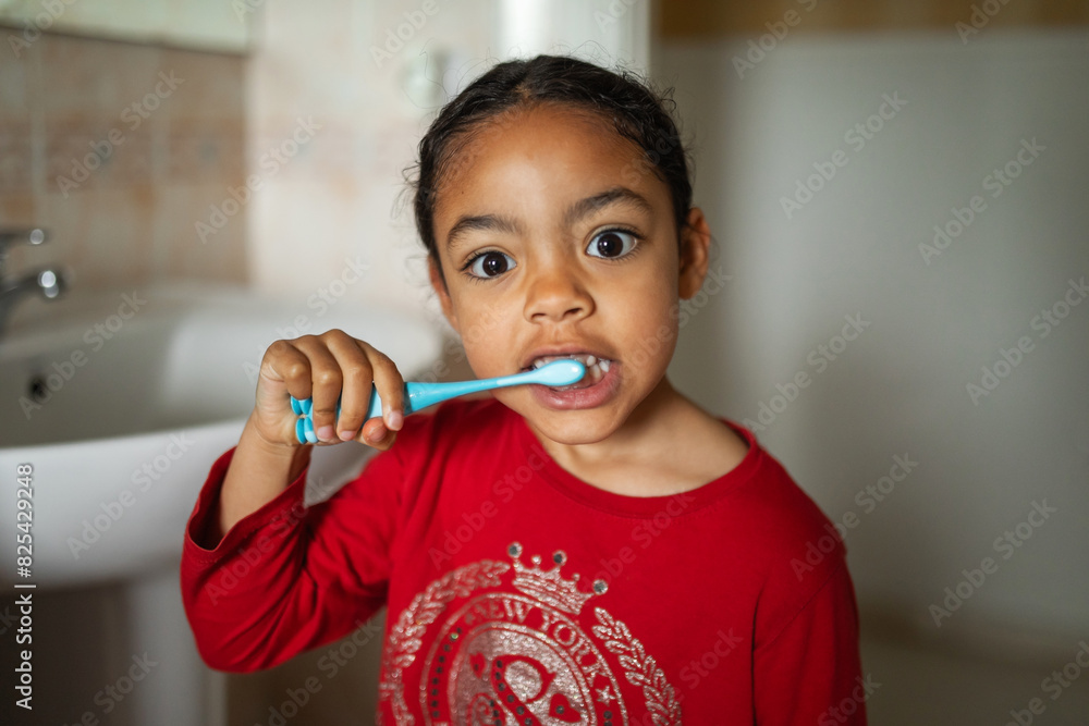 black girl brushing her teeth in the bathroom at home Stock Photo ...