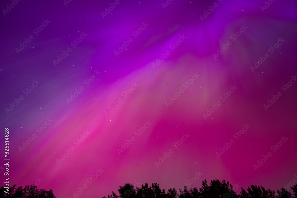 Mesmerizing display of purple, pink, and red aurora borealis over ...