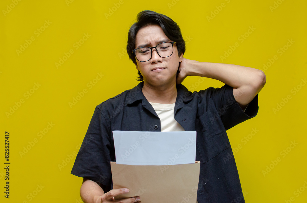 asian man opening envelope receiving and reading bad news letter. An ...