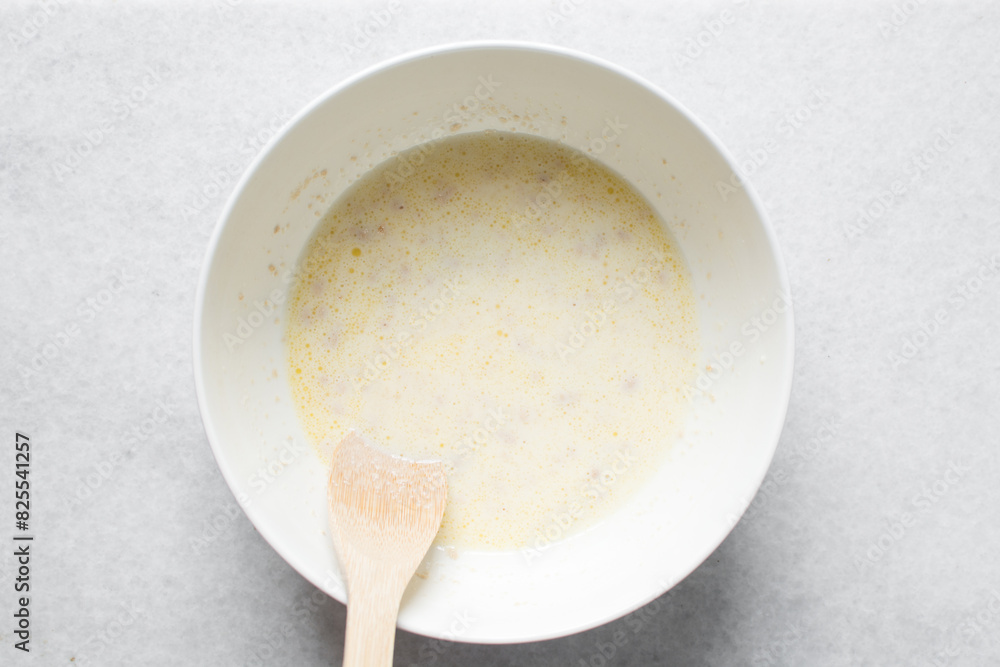 Activated yeast with milk and melted butter, dry yeast granules on milk ...