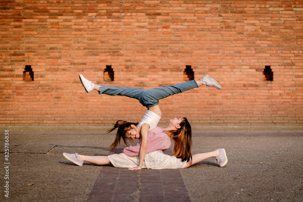 Beautiful girls perform a synchronized acrobatic pose. Performance ...