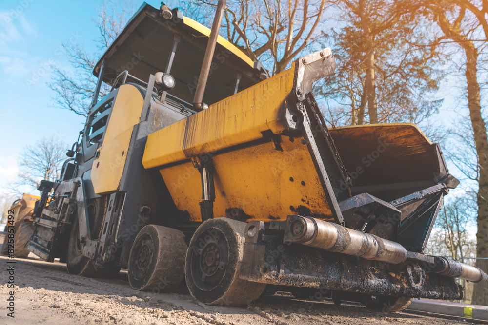Big Asphalt paver with hot tarmac laying new road construction site ...