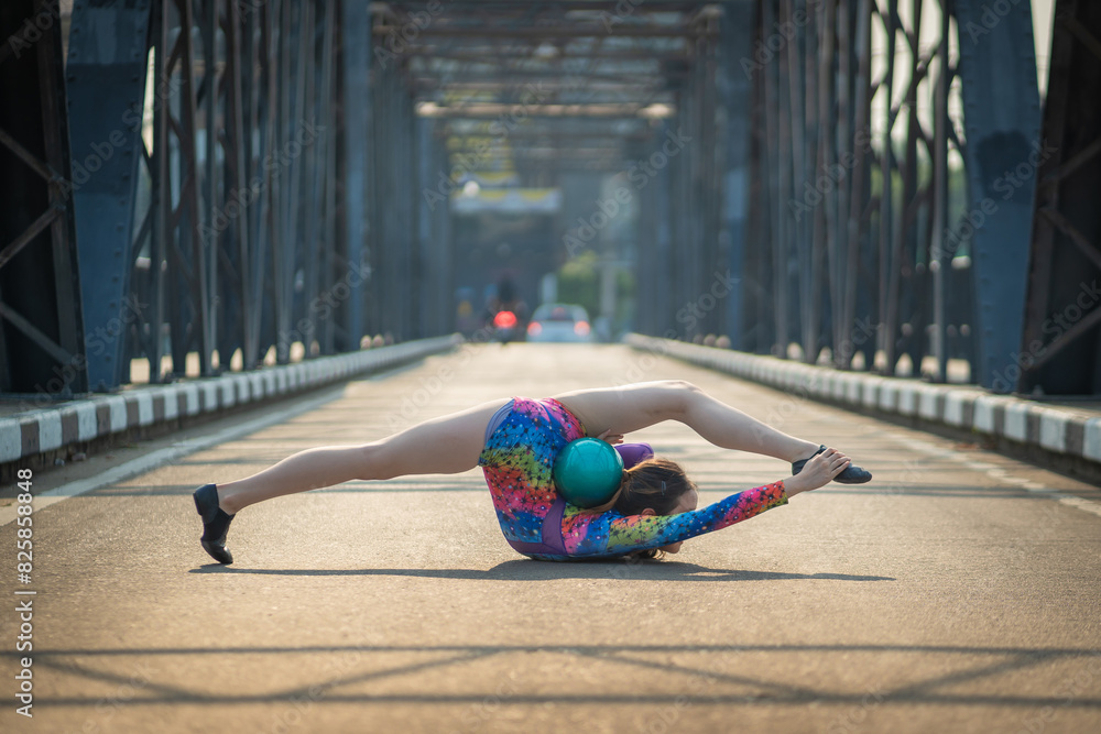 Beautiful Asian girl performs an acrobatic pose. Performance Street ...